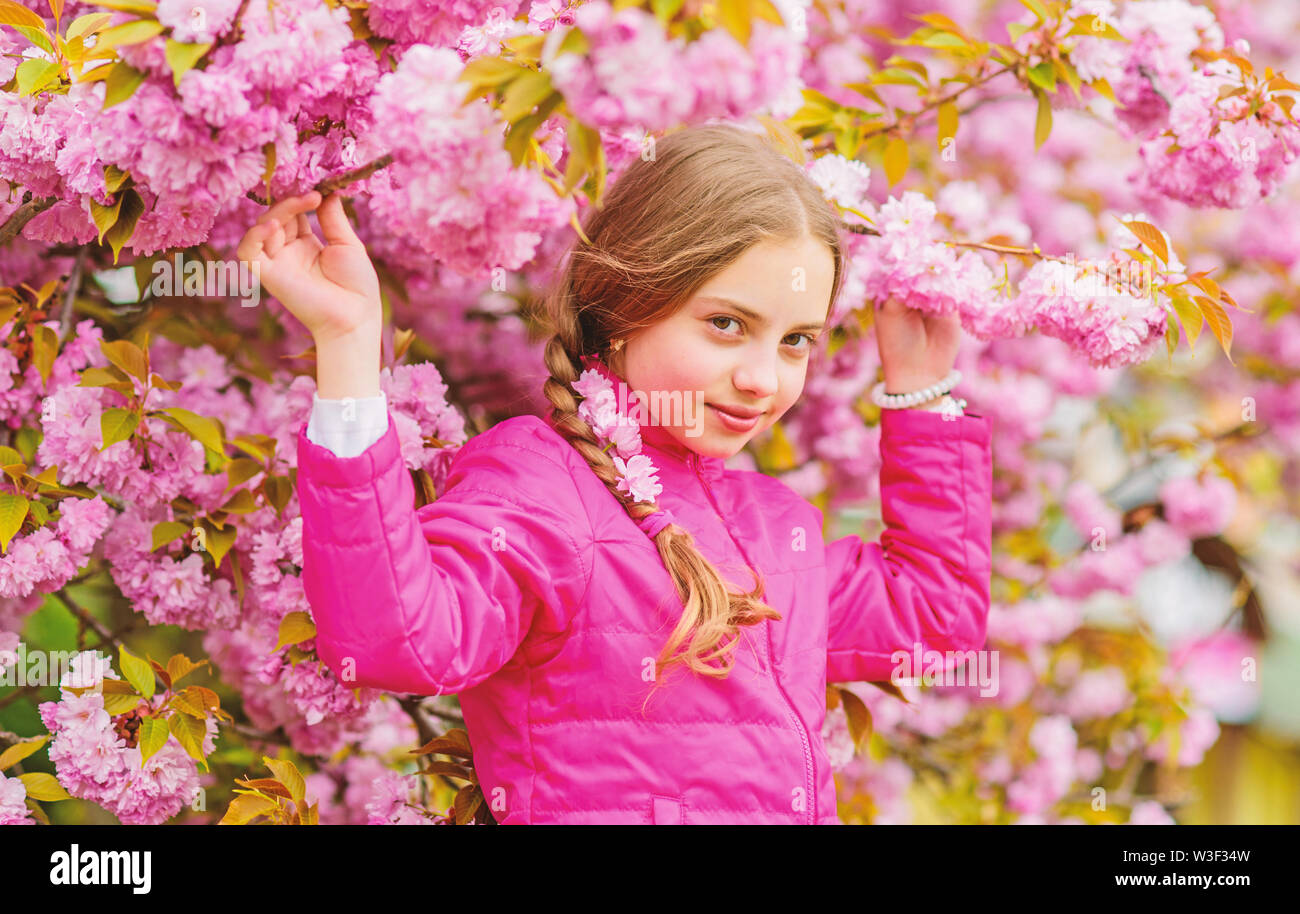 Little girl enjoy spring. Kid on pink flowers of sakura tree background ...