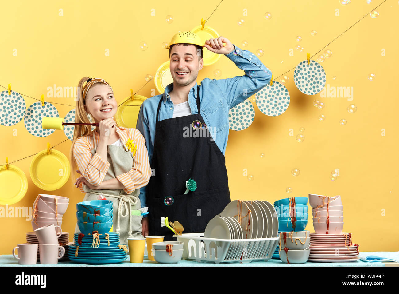 funny man with colander on his head while his wife looking at him with ...