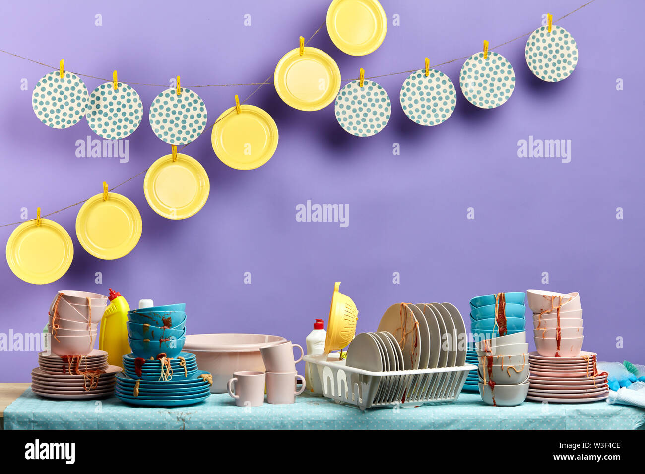 pile of dirty used dishes waiting for wash. clean tables hanging on the ...