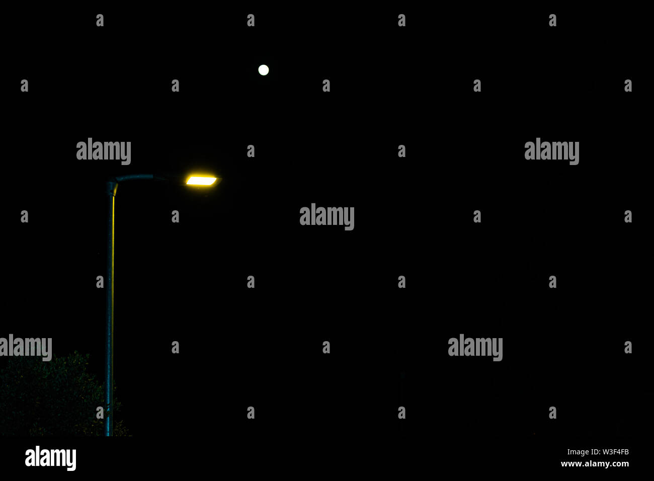 Moon over street light Stock Photo - Alamy