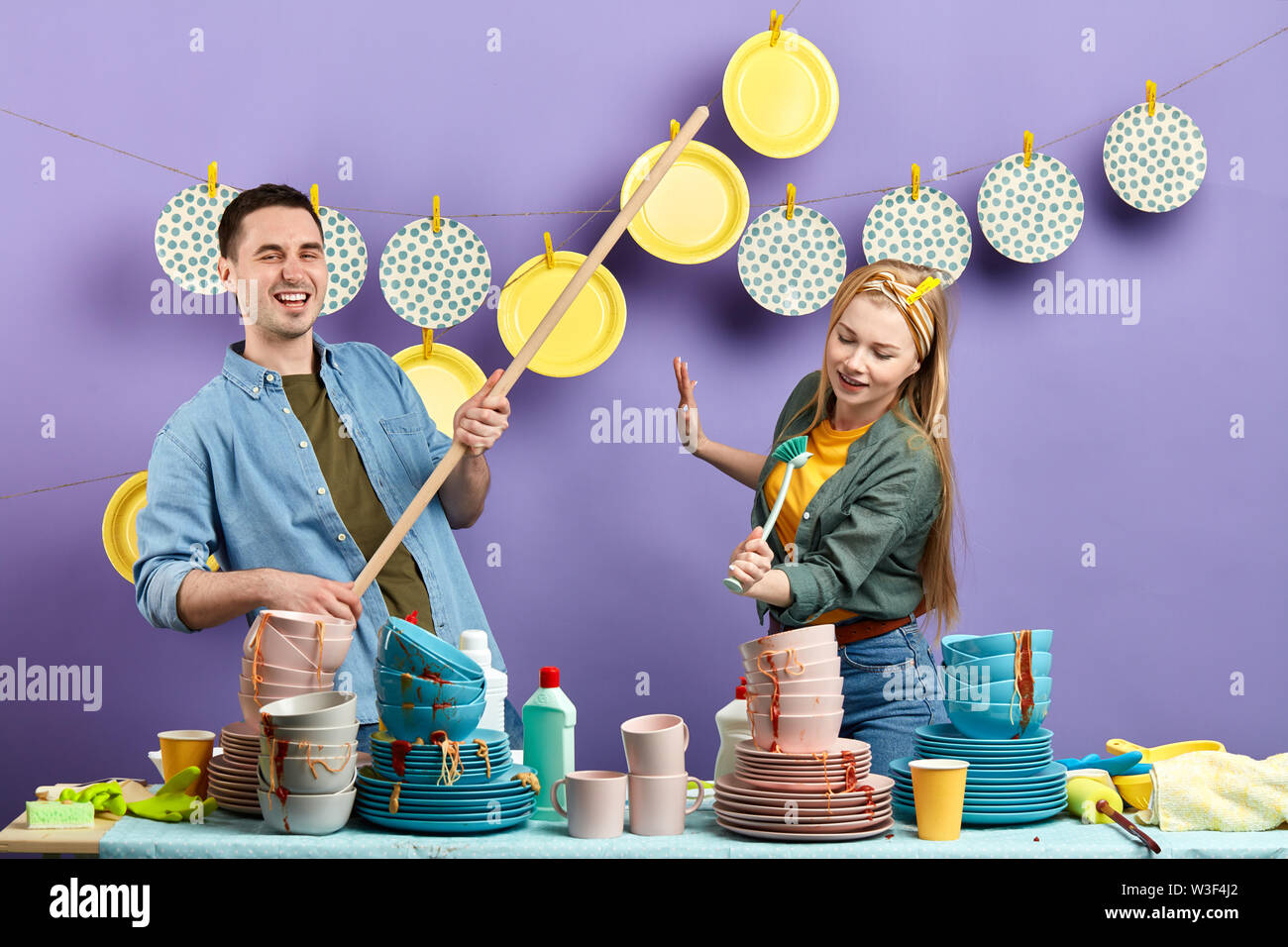 creative talented man and woman pretending singing songs and dancing in ...