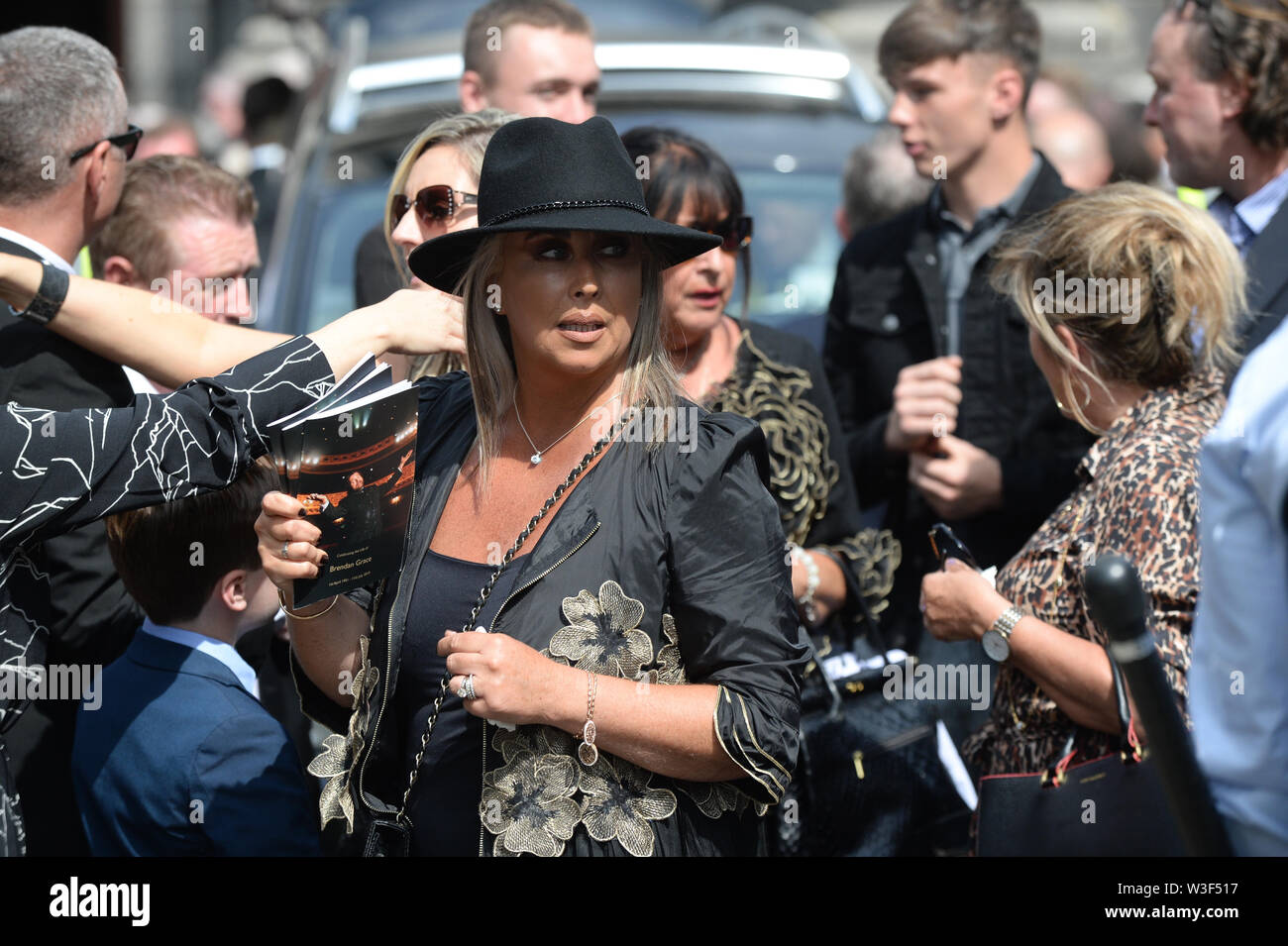 Family members at the funeral of Father Ted star Brendan Grace at the ...