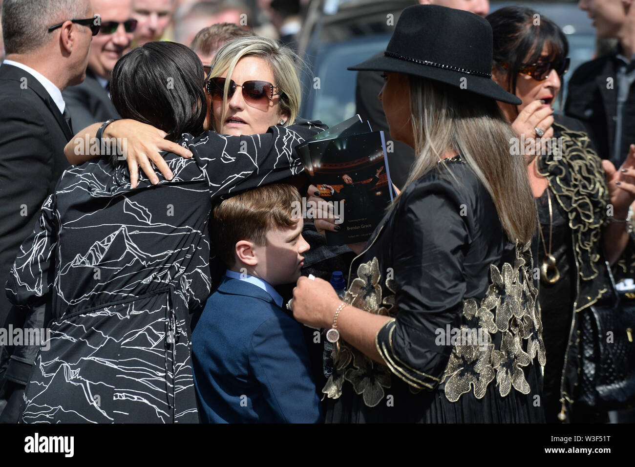 Family members at the funeral of Father Ted star Brendan Grace at the ...
