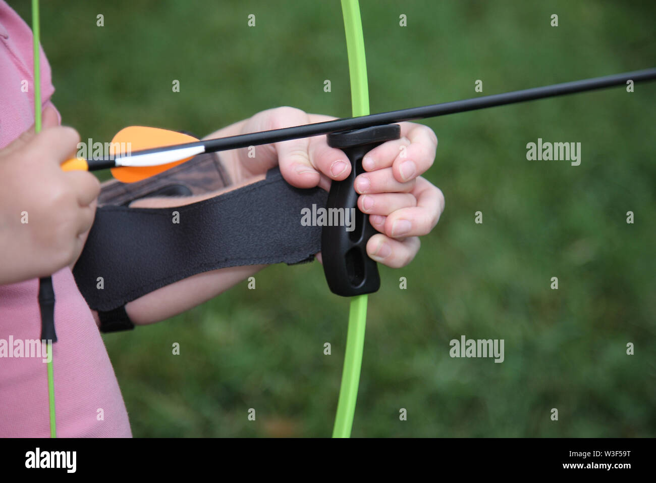 Teaching traditional archery to young girl Stock Photo - Alamy
