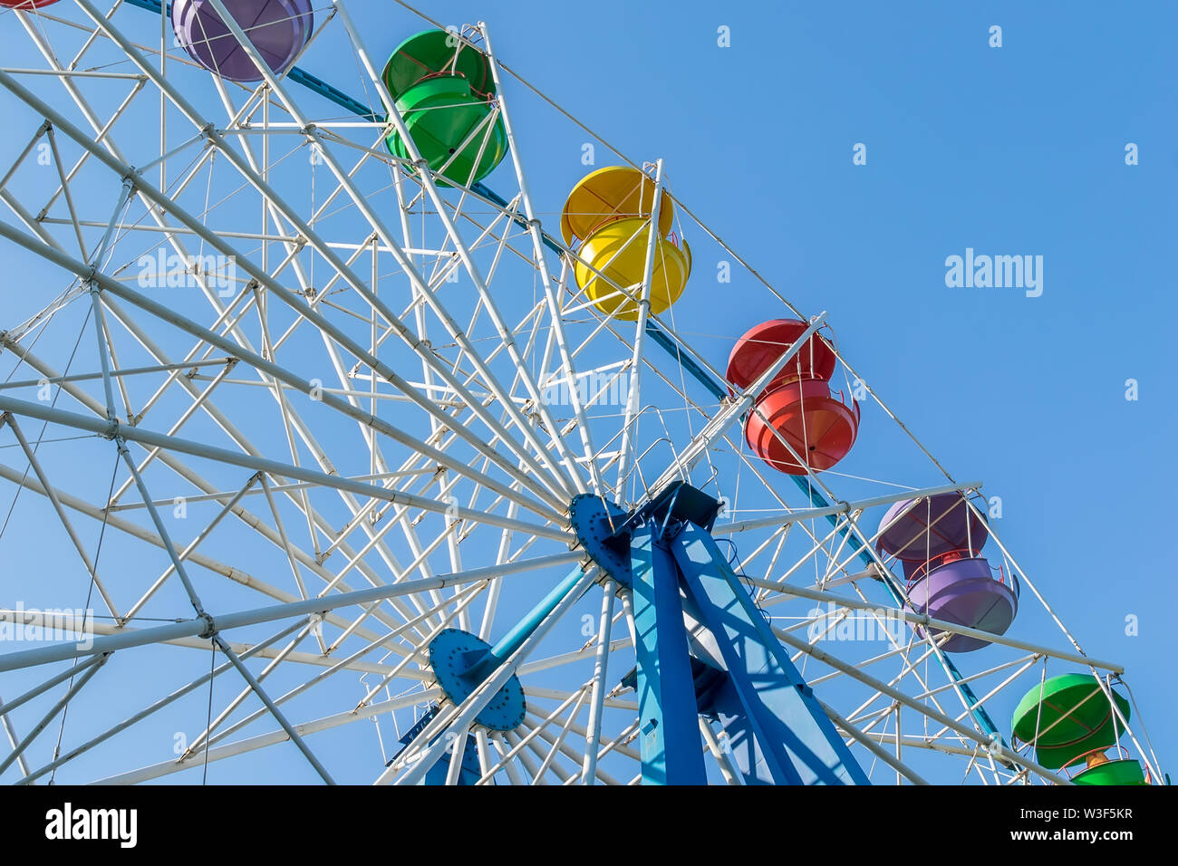 ferris wheel from the amusement Park with colorful baskets of seats ...