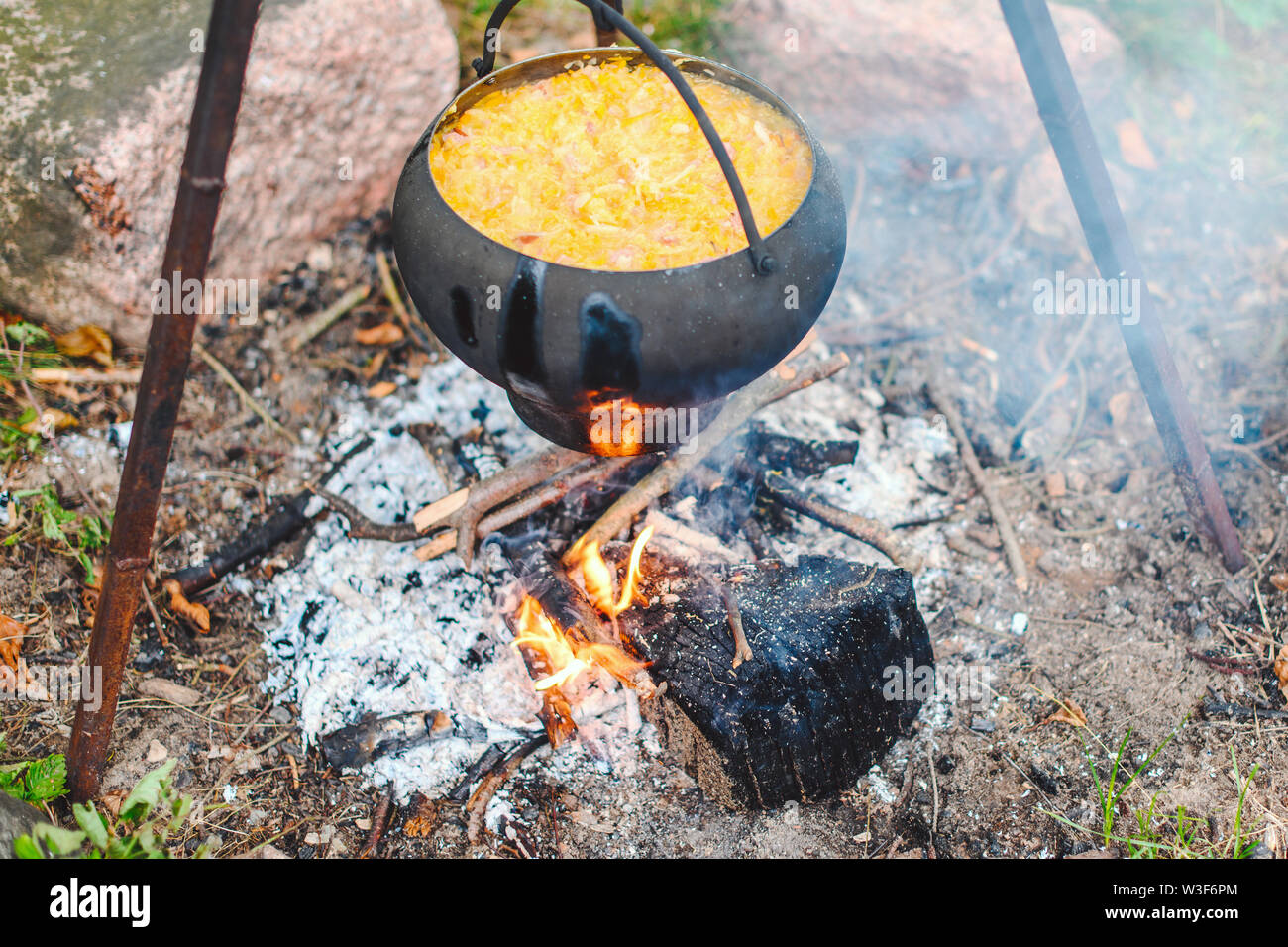 Cooking cabbage soup on a bonfire Stock Photo - Alamy