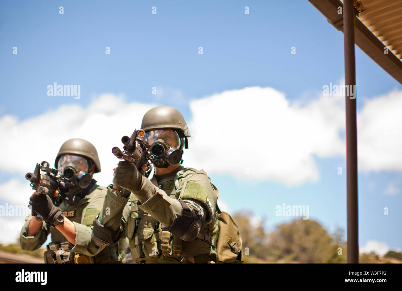 Two police officers point a gun towards a target during an exercise at ...