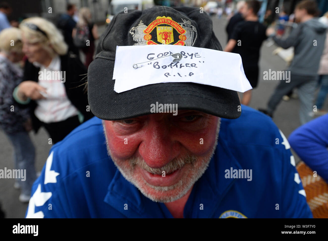 A mourner at the funeral of Father Ted star Brendan Grace outside the ...