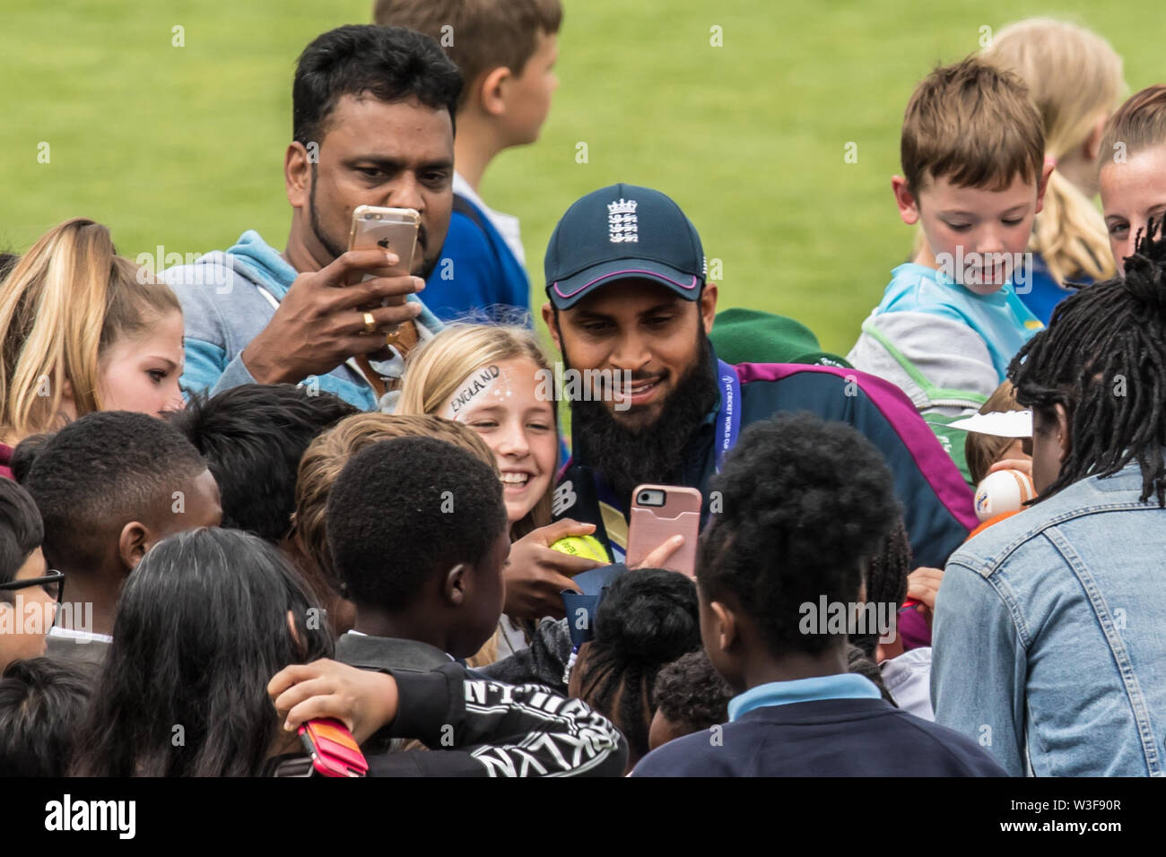 London, UK. 15 July, 2019. Adil Rashid poses for selfies for the crowd ...