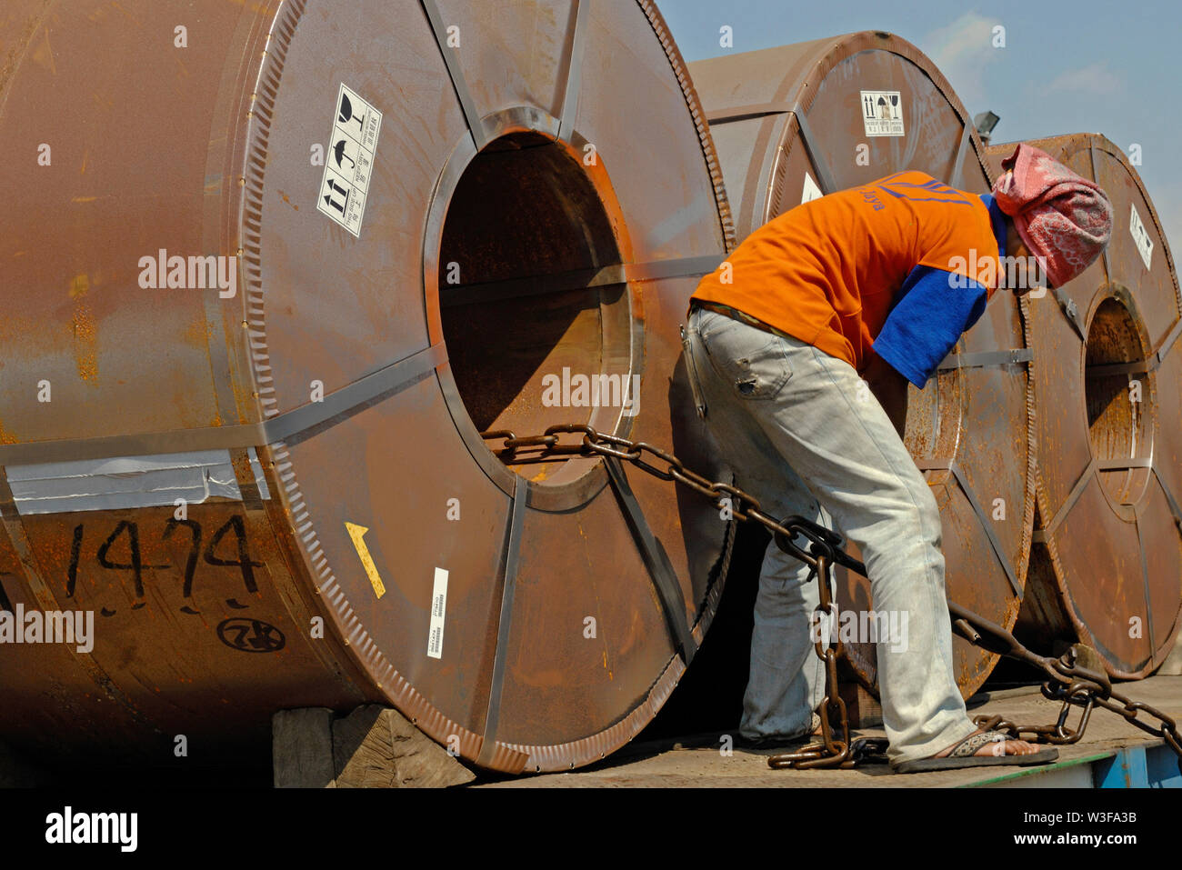 jakarta, dki jakarta/indonesia - may 24, 2007: a port worker lashing ...