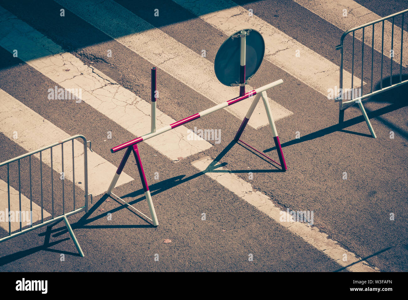 Temporary road sign on city street with pedestrian crossing during ...