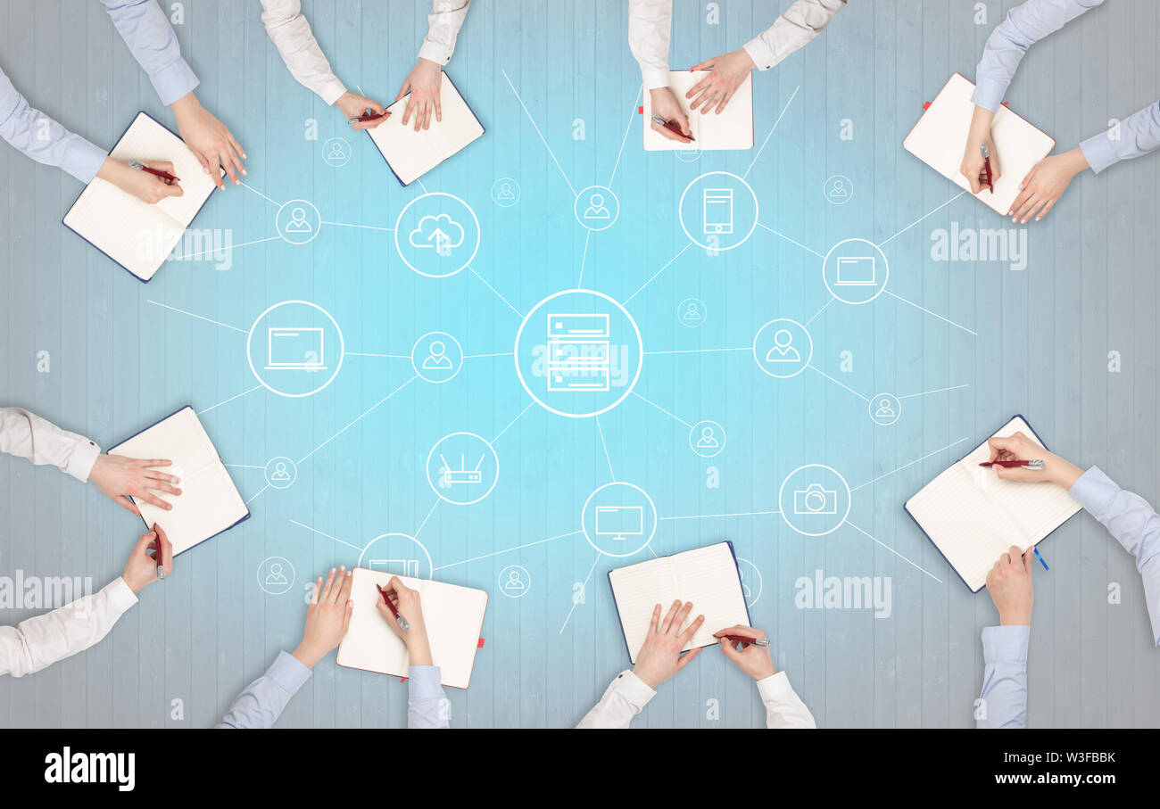 Group of people with devices in hands working in team on tablets ...