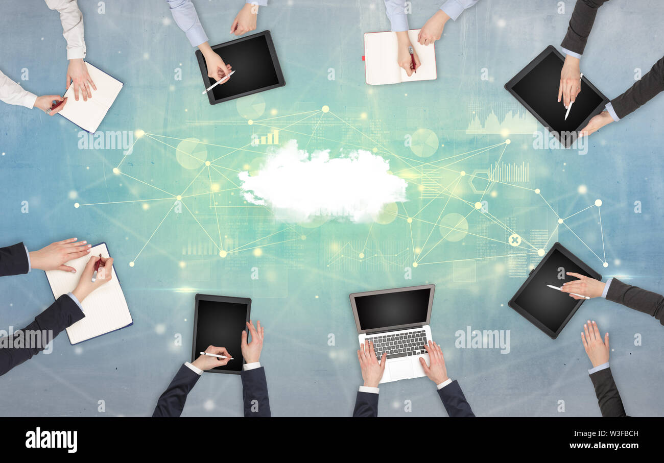 Group of people with devices in hands working on reports with online ...