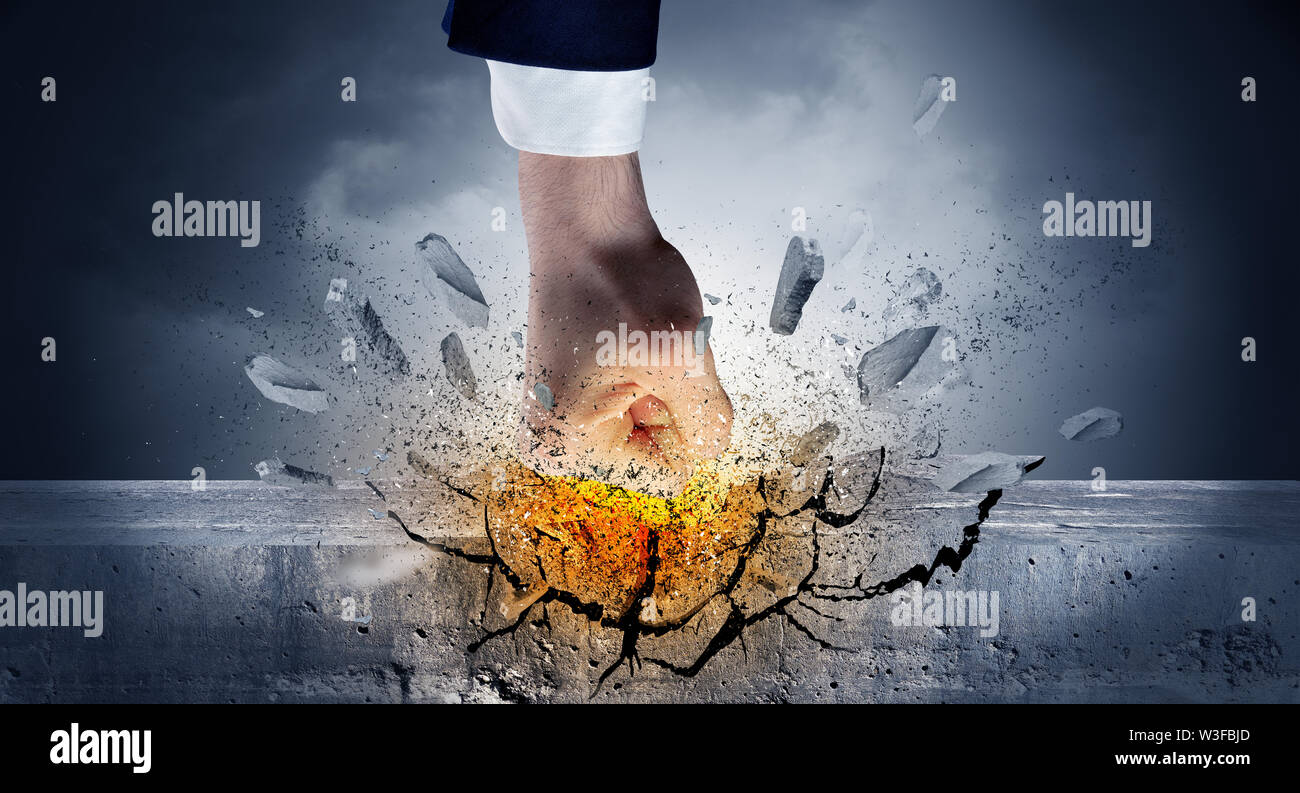 Big hand hits intense and breaks a crass stonewall Stock Photo - Alamy