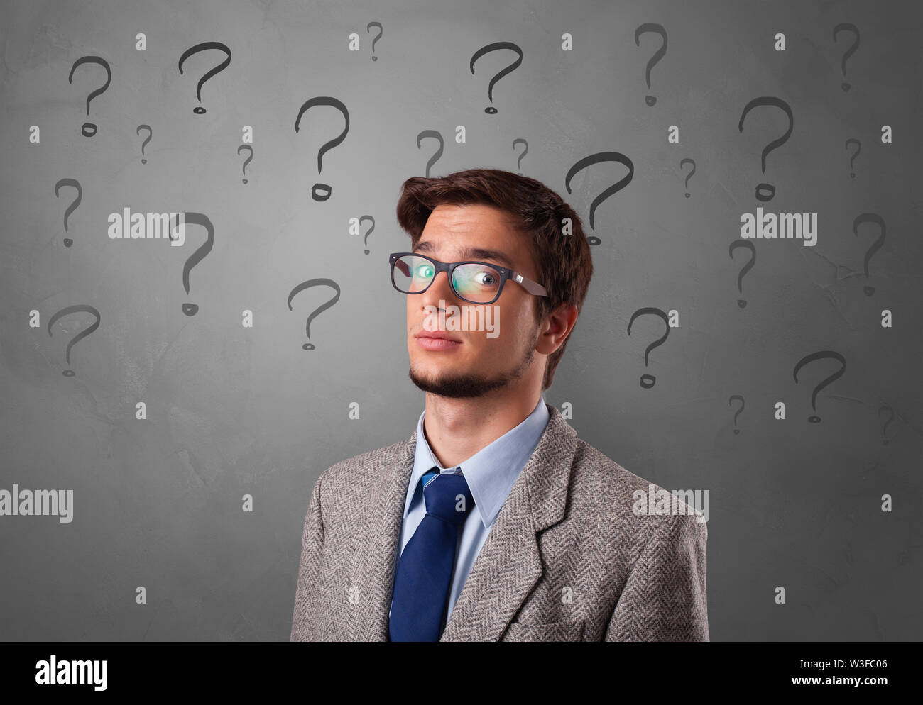 Person with question marks around face Stock Photo - Alamy