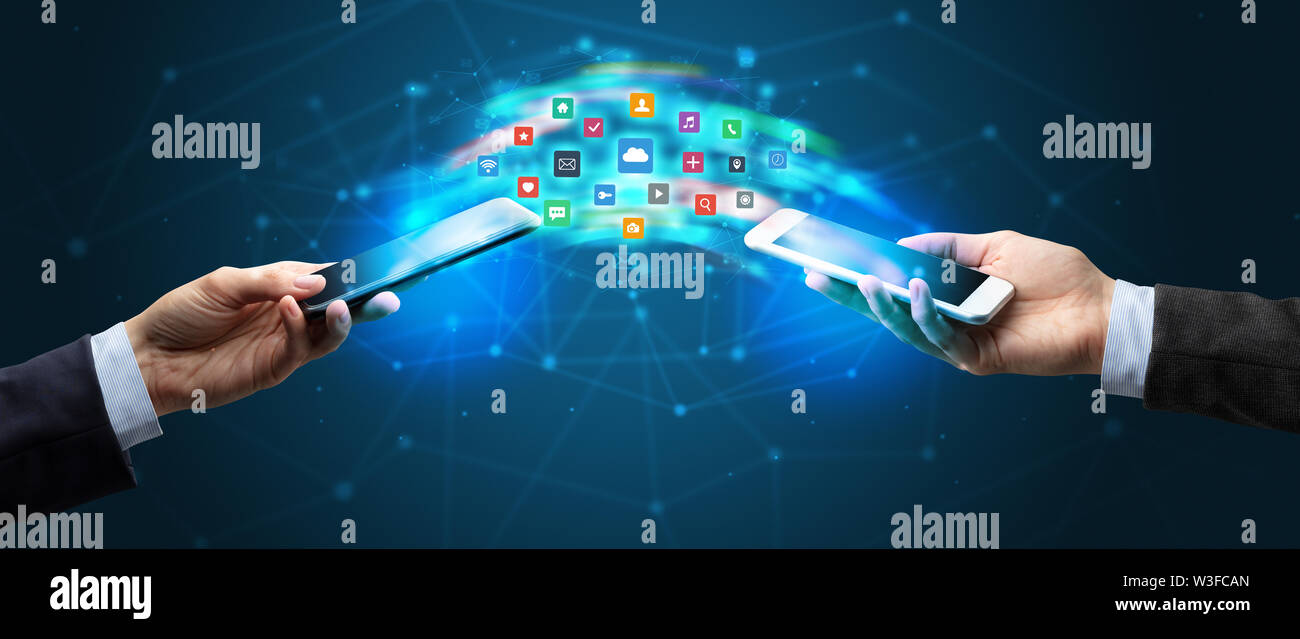 Two mobile phones syncing applications concept Stock Photo - Alamy
