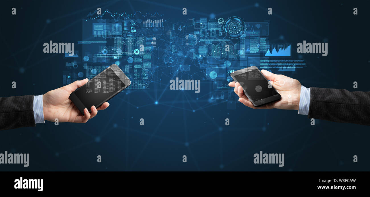 Close up of two hands holding smartphones to sync business data Stock ...