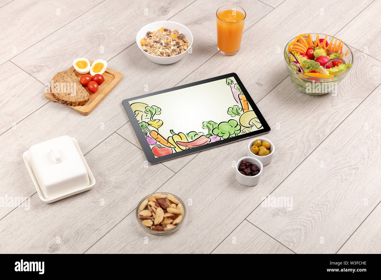 Healthy food composition with tablet Stock Photo - Alamy