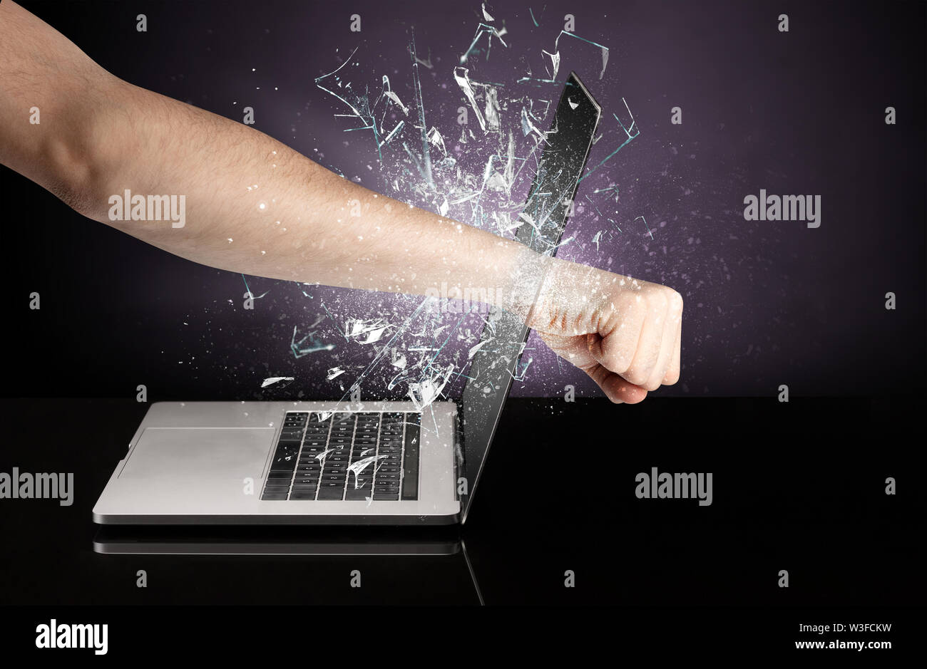 Hand hitting strongly laptop screen glass Stock Photo - Alamy