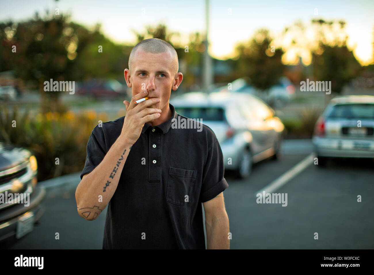 Man smoking in car park Stock Photo - Alamy