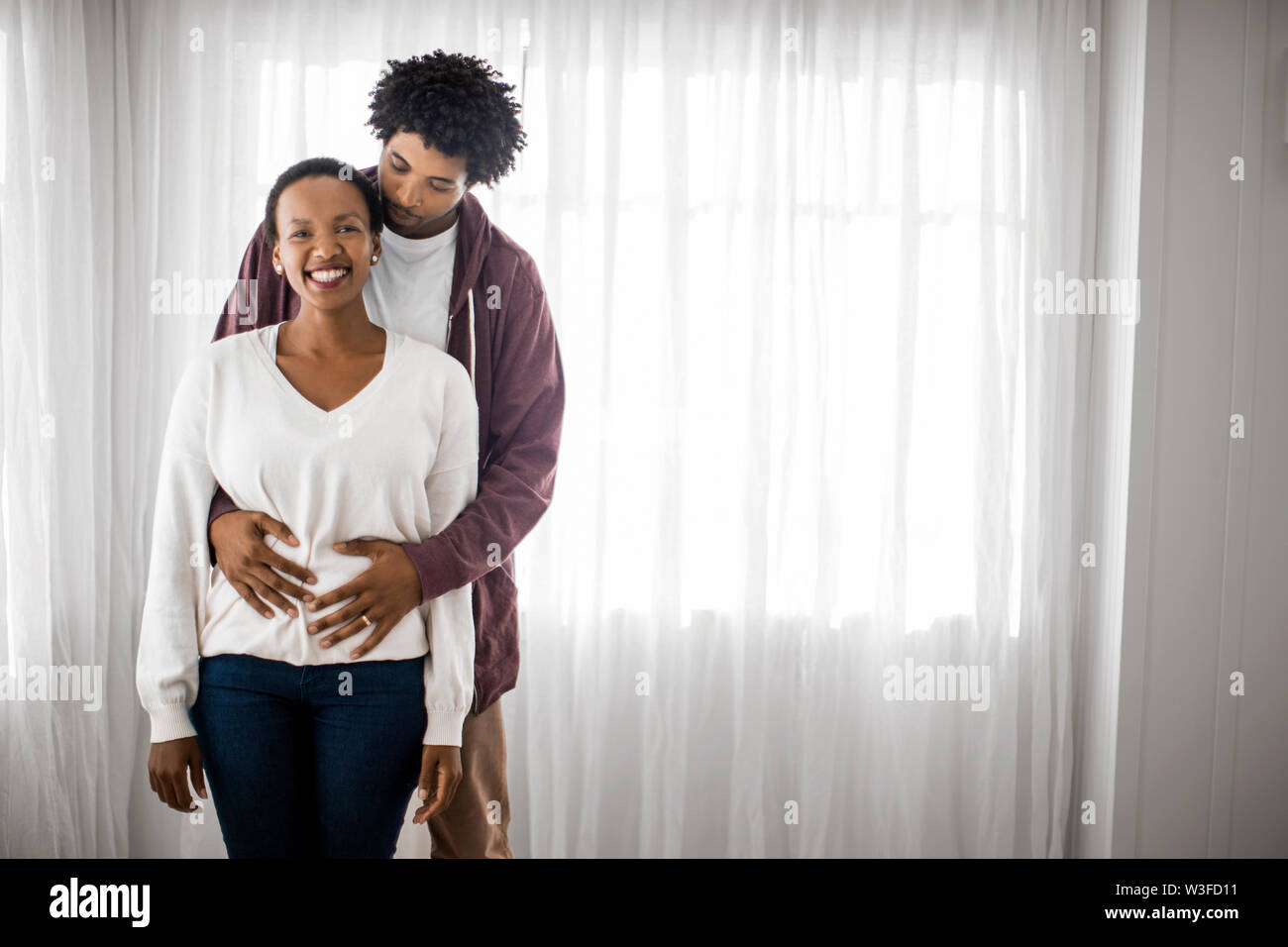 Happy young man embracing his beautiful partner Stock Photo - Alamy