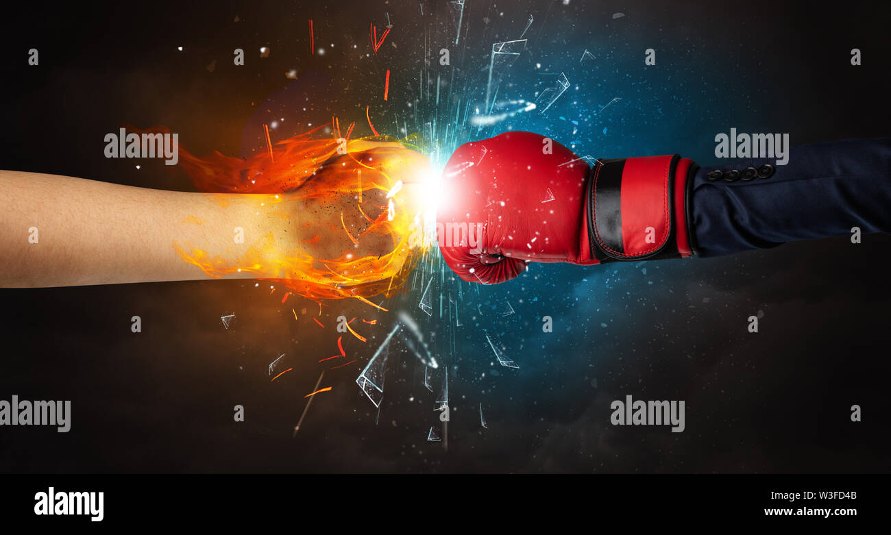 Two hands fighting and breaking glass into small pieces with fire and ...