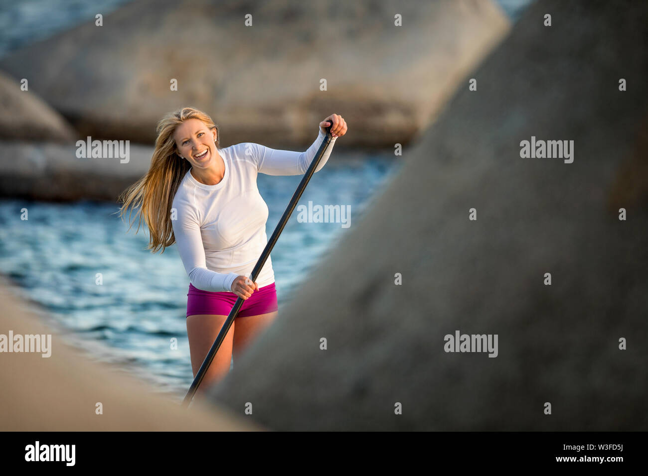 Smiling woman holding paddle hi-res stock photography and images - Alamy