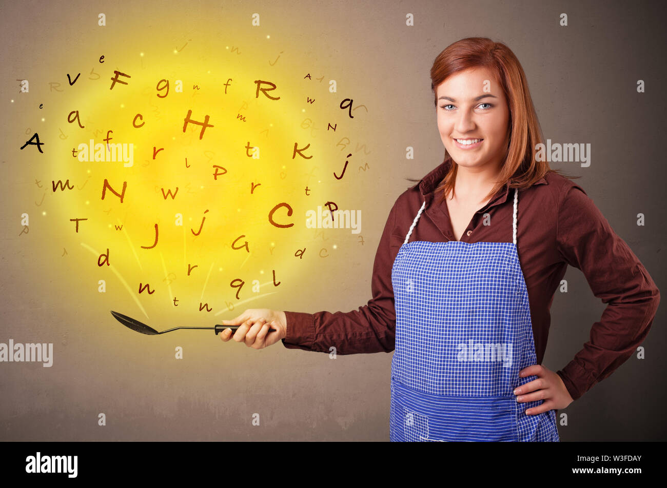 Young person cooking letters in wok Stock Photo - Alamy