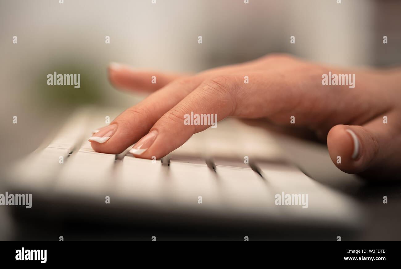 Hand typing on keyboard with office concept Stock Photo - Alamy