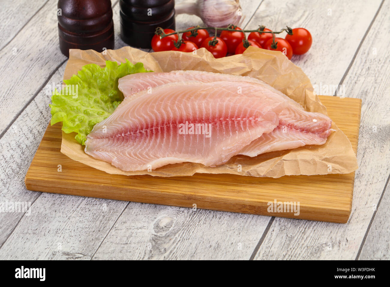 Raw tilapia fish ready for cooking Stock Photo - Alamy