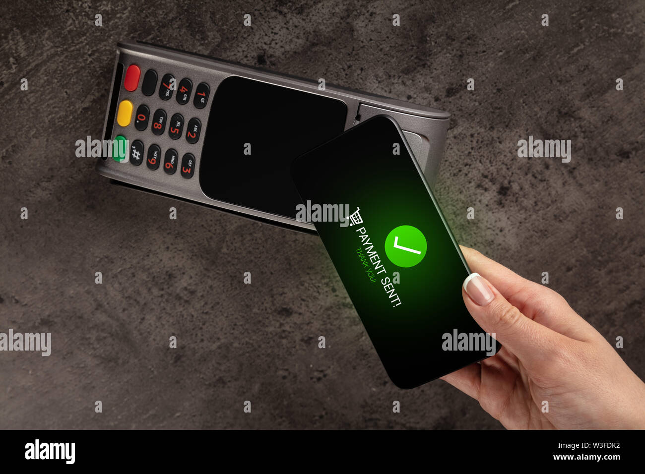 Mobile payment accepted on terminal Stock Photo - Alamy