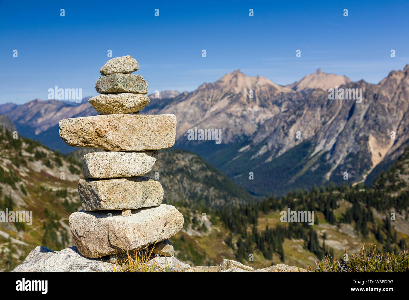Stack of stones rocks trail marker cairn in the mountains, North ...