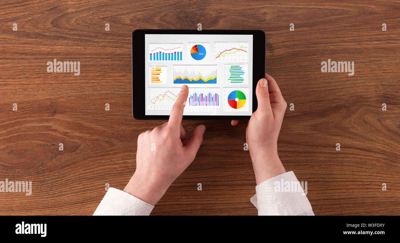 Hand making diagrams and charts on tablet Stock Photo - Alamy