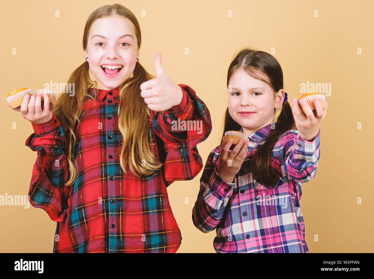 Yummy muffins. Girls cute kids eating muffins or cupcake. Sweet dessert ...