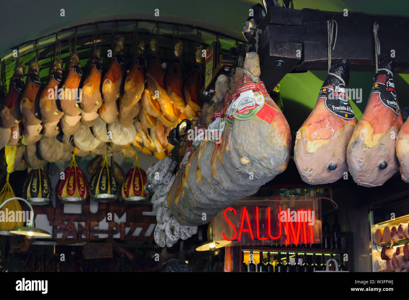 Rome, Italy 19 JUN 2019 Various types of huge smoked hams hanging in ...