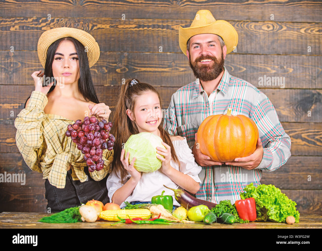 Parents and daughter celebrate autumn harvest festival. Family farm ...