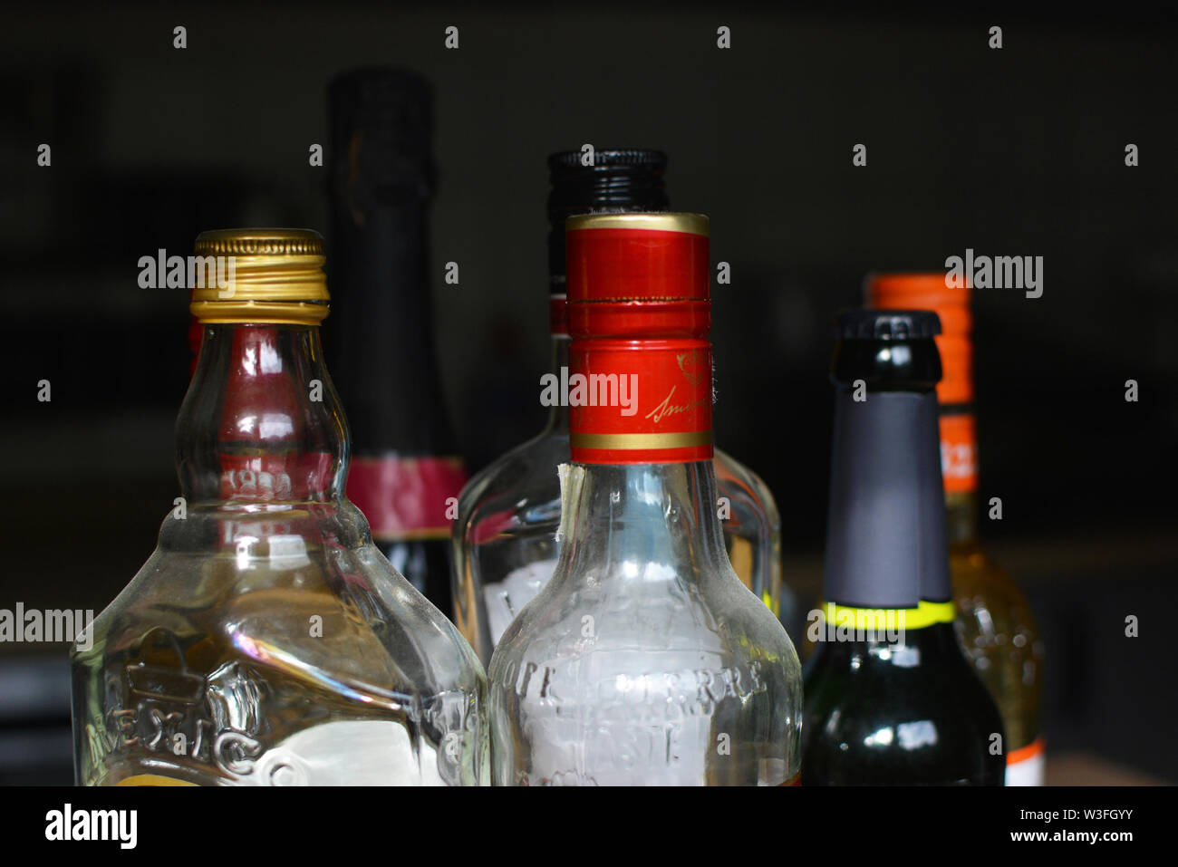 Multiple different strong spirits alcohol bottles on black background ...