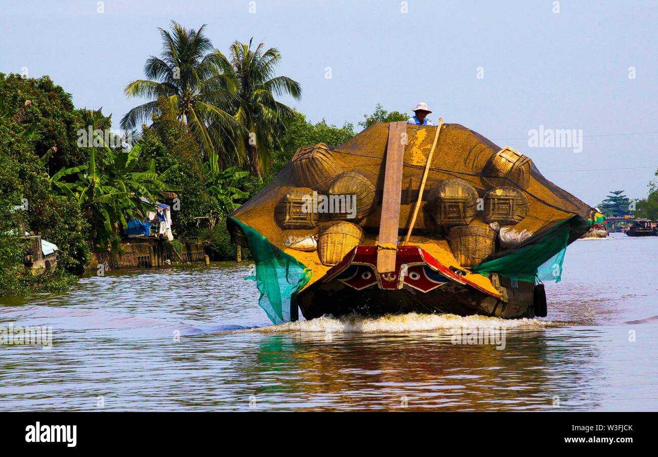 MEKONG DELTA, VIETNAM: DECEMBER 30. 2014: Overloaded sampan style boat ...