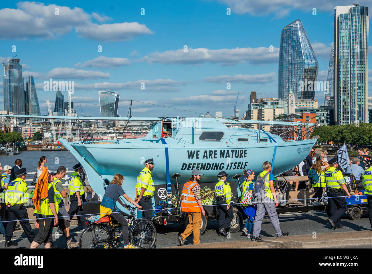 London, UK. 15th July 2019. The boat is towed over Waterloo Bridge by ...