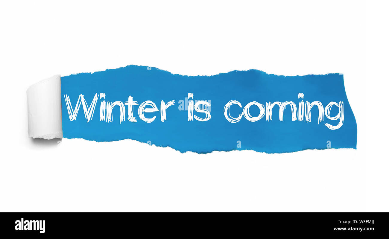 The text Winter is coming written under the curled piece of Blue torn ...