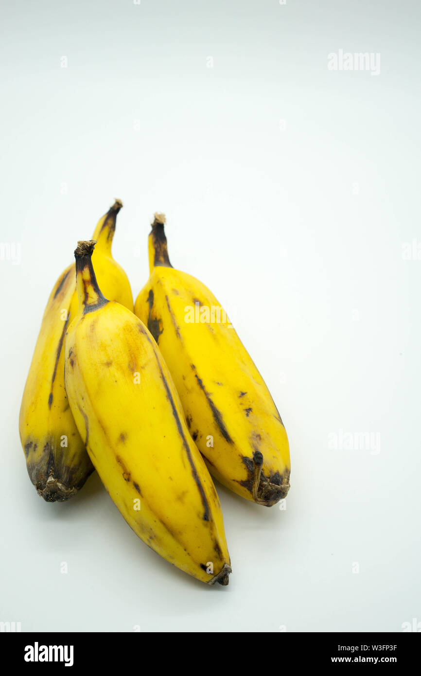 three ripe short bananas isolated white background Stock Photo - Alamy