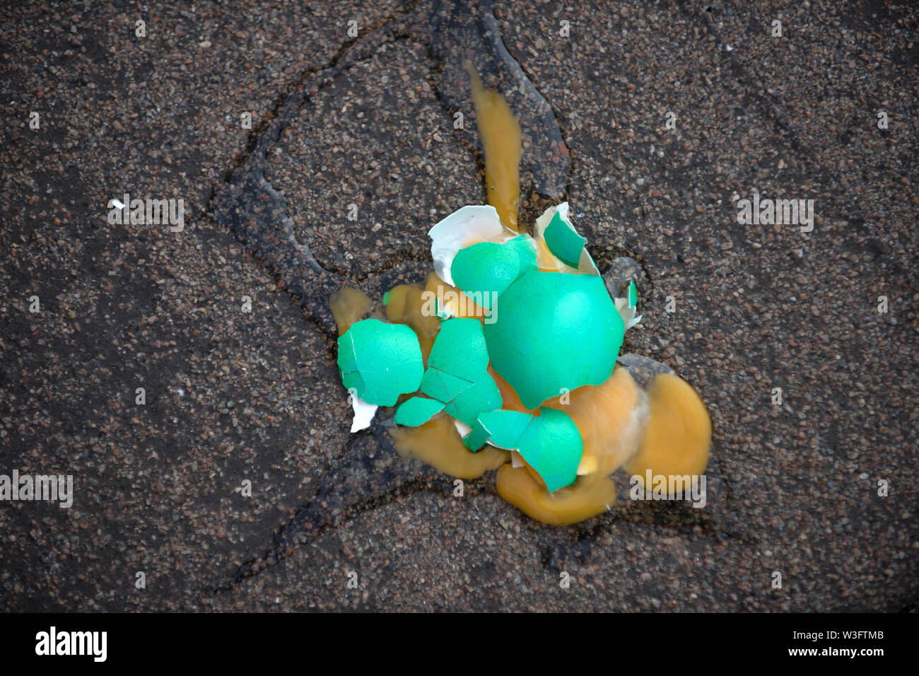 Easter egg broken on asphalt background Stock Photo - Alamy