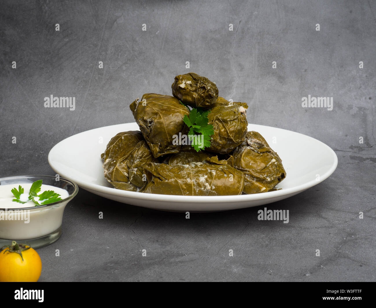 Traditional georgian dolma in grape leaves with parsley, cream ...