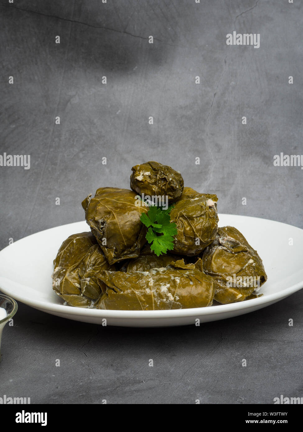 Traditional georgian dolma in grape leaves with parsley, cream ...