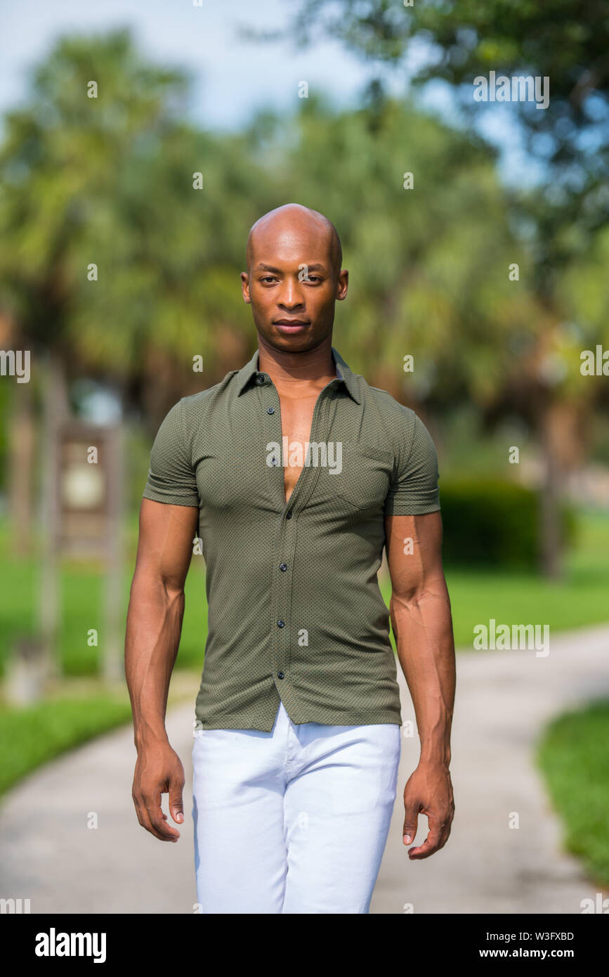 Photo series of a man walking towards the camera down a park pathway ...