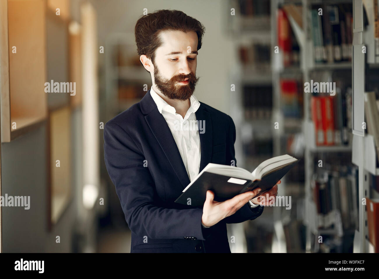 Handsome guy study at the library Stock Photo - Alamy