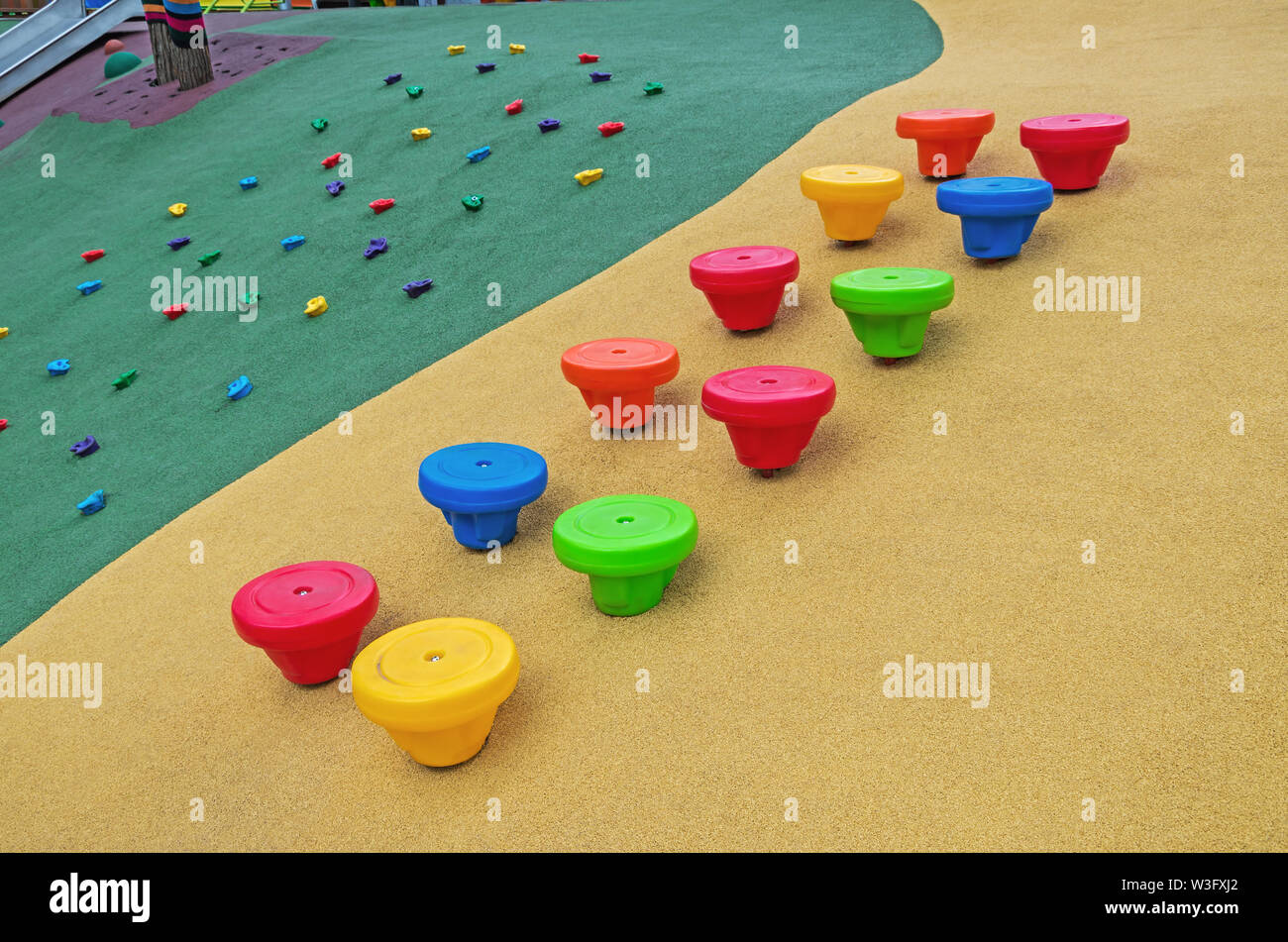 Children playground with multi-colored plastic stumps for climbing and ...