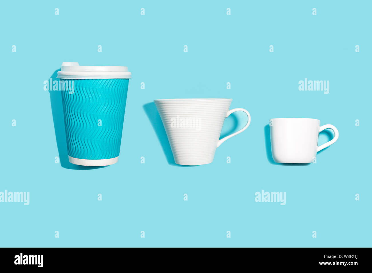 Coffee pattern of white ceramic and blue paper cup for coffee on bright ...