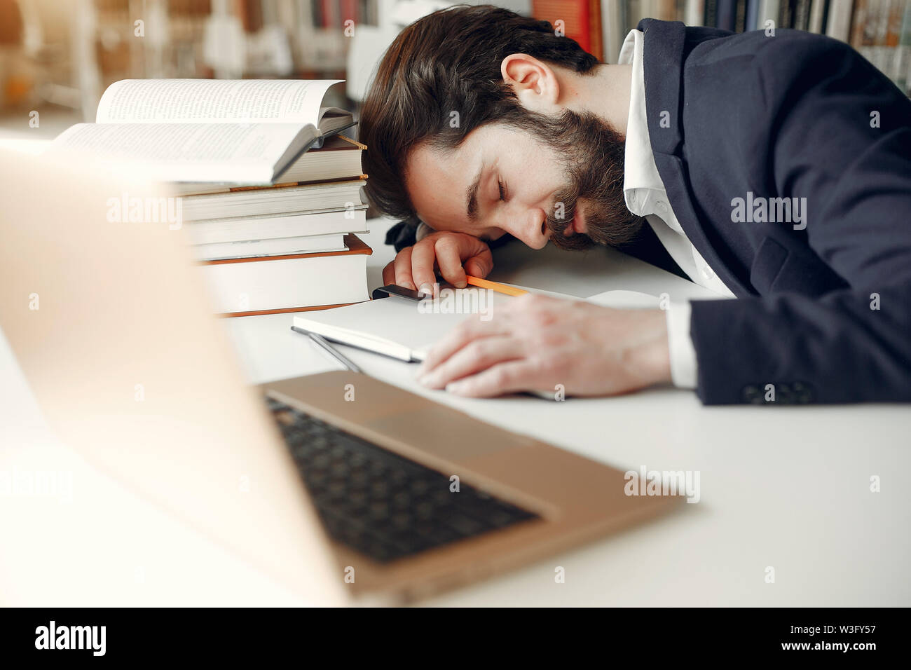 Handsome guy sitting table studying hi-res stock photography and images ...