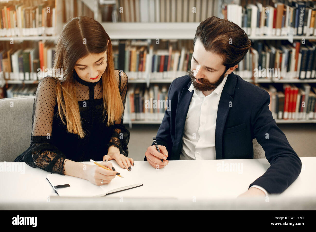 Two students study at the library Stock Photo - Alamy